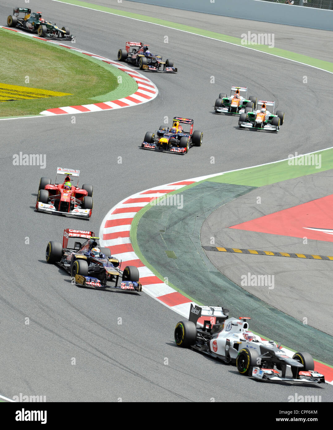 eight cars race through the first curve during the Formula 1 Grand Prix ...