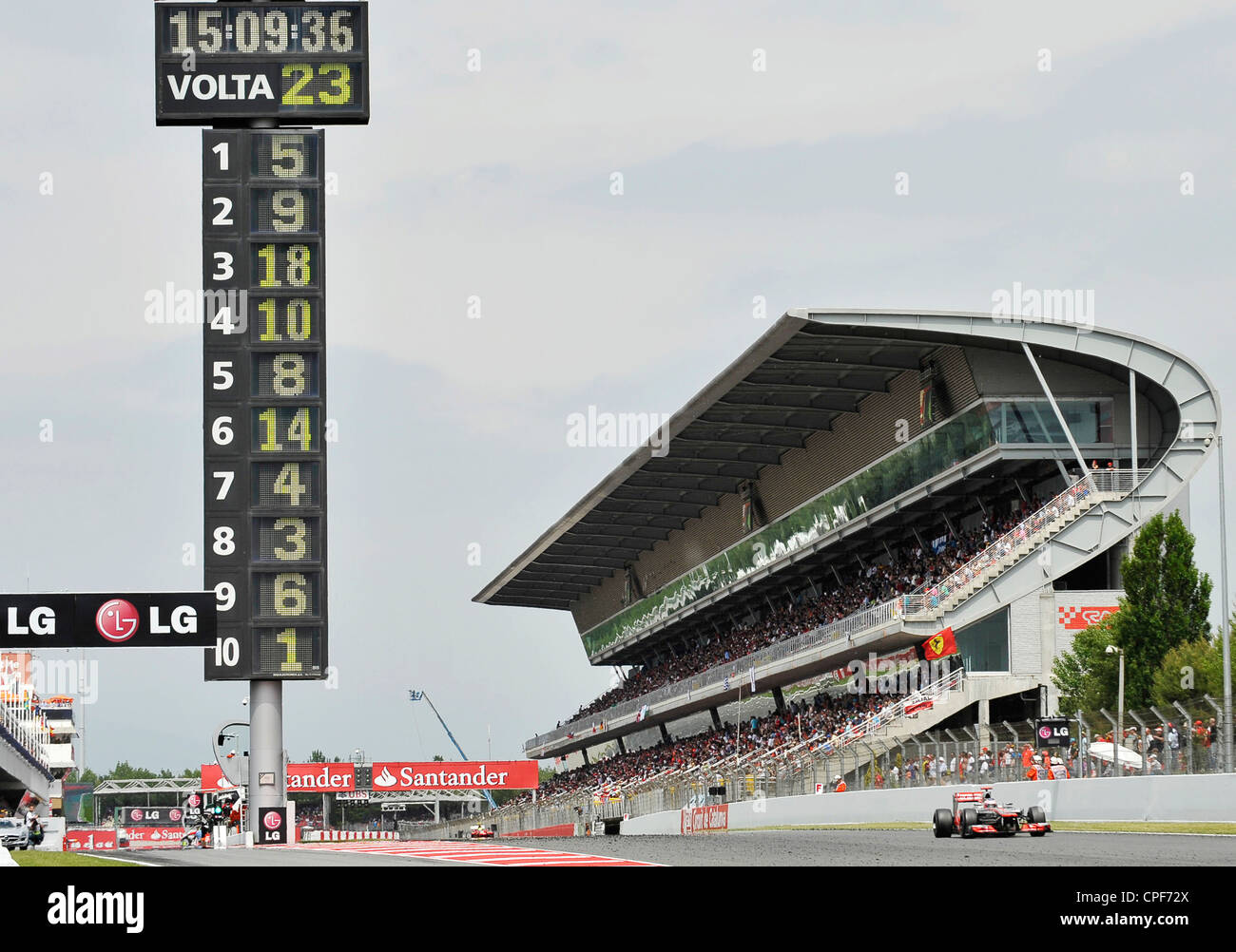 McLaren races down the start finish strait in front of the grandstand ...