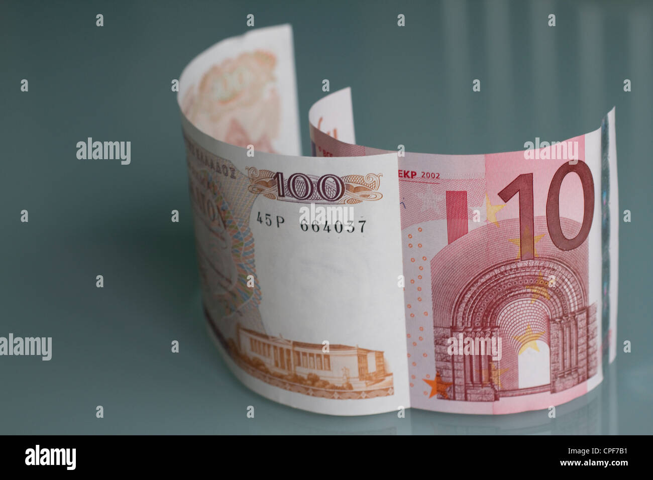 Greek banknotes displaying both euros and drachmas, the former national ...