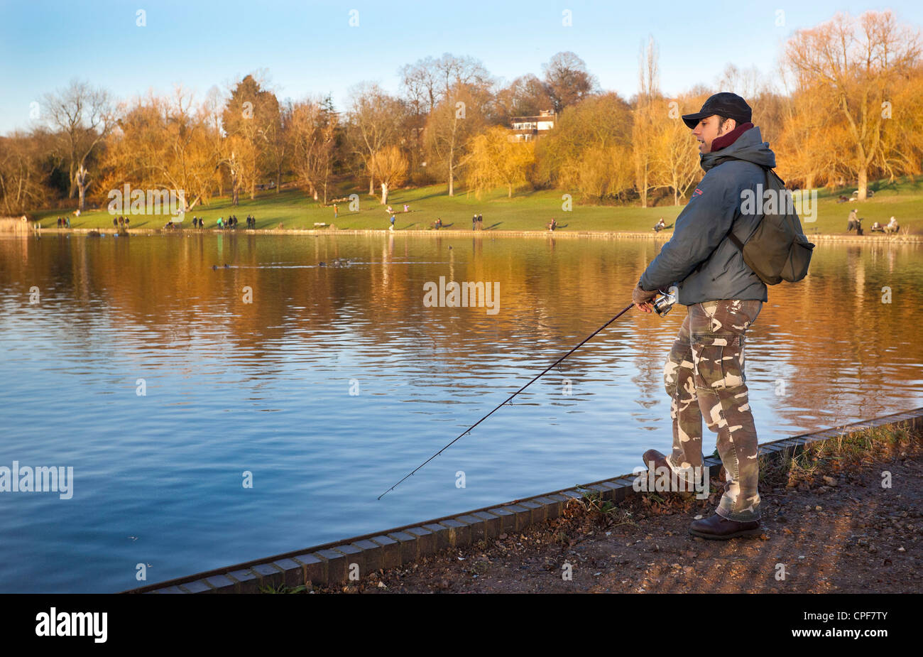 Full length portrait of a fisherman fishing at a pond, Hampstead Heath ...