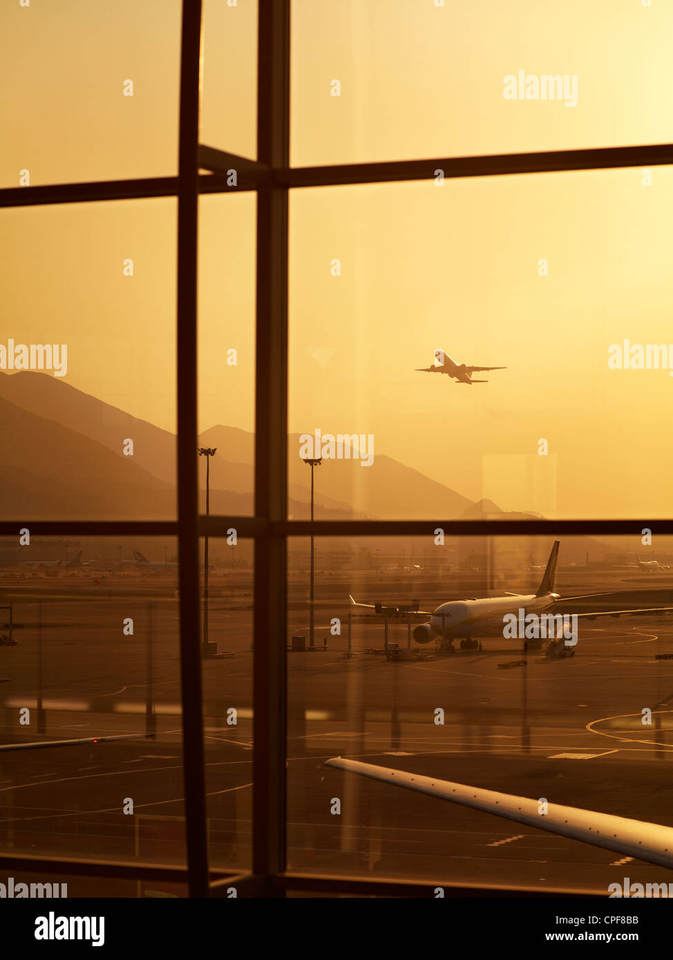 A sunset view of airplanes taking off at the Hong Kong International ...