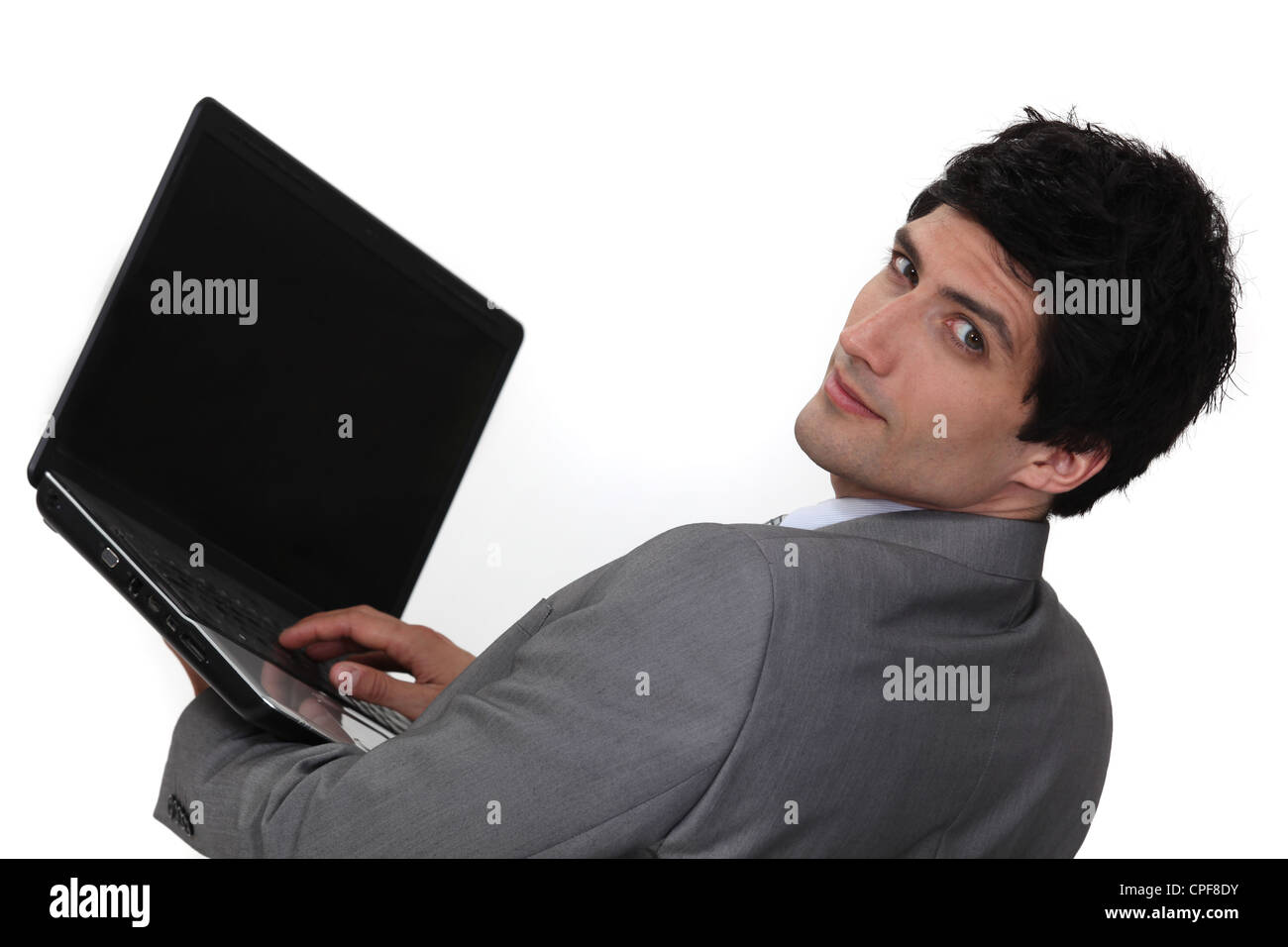 Businessman holding laptop Stock Photo - Alamy