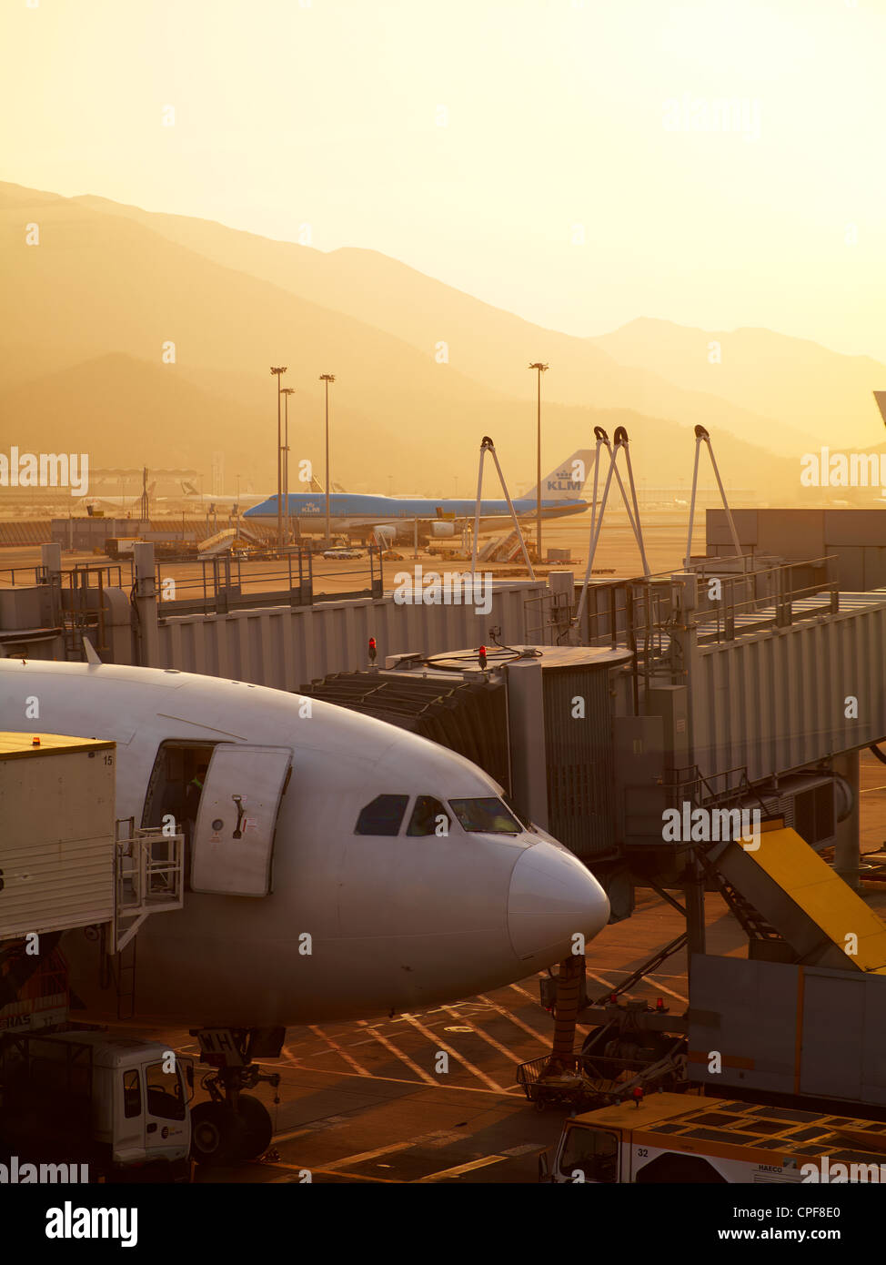A sunset view of airplanes taking off at the Hong Kong International ...