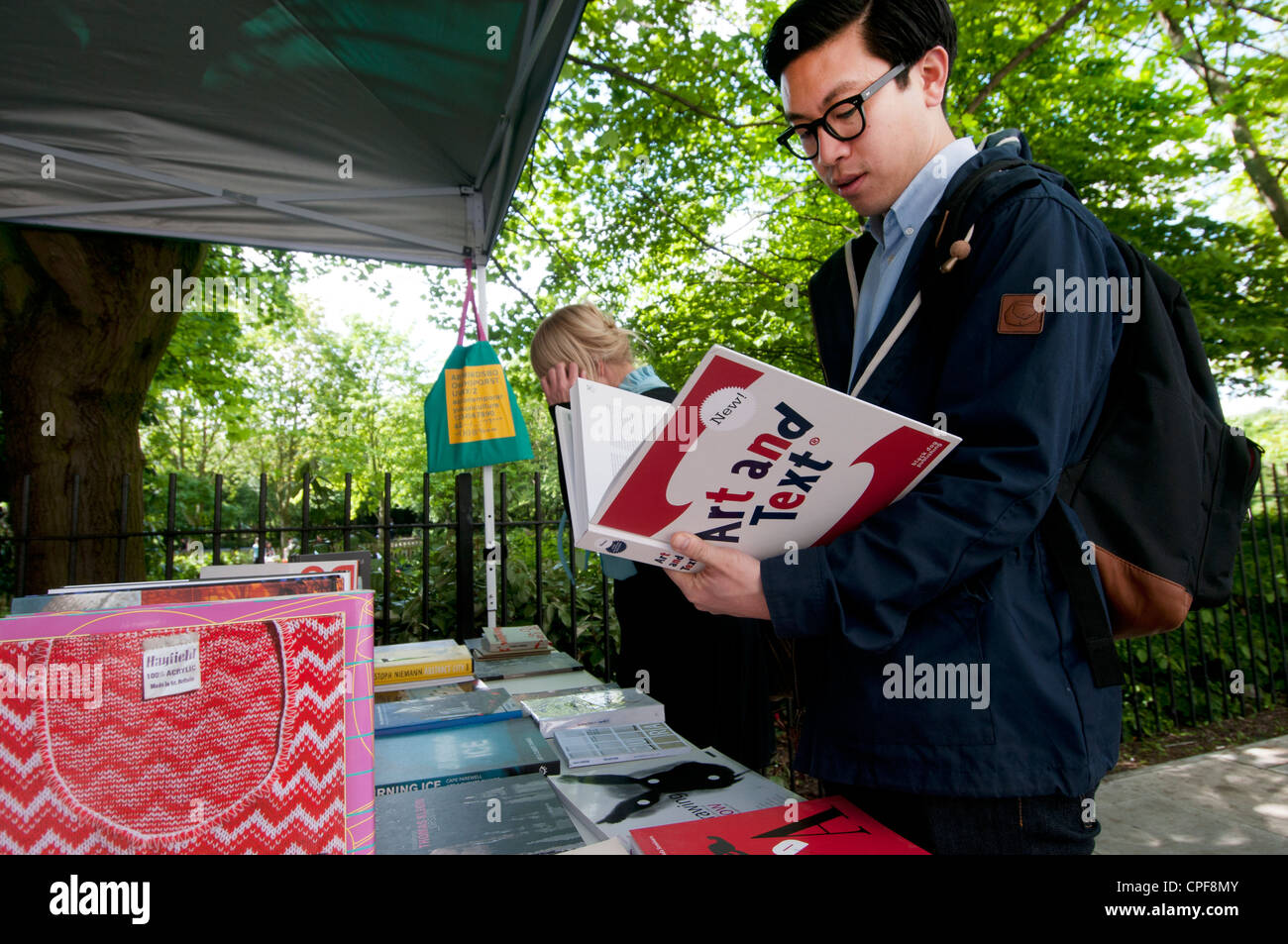 Goldsmith Row Hackney. Sunday morning book market. Asian man looking at ...