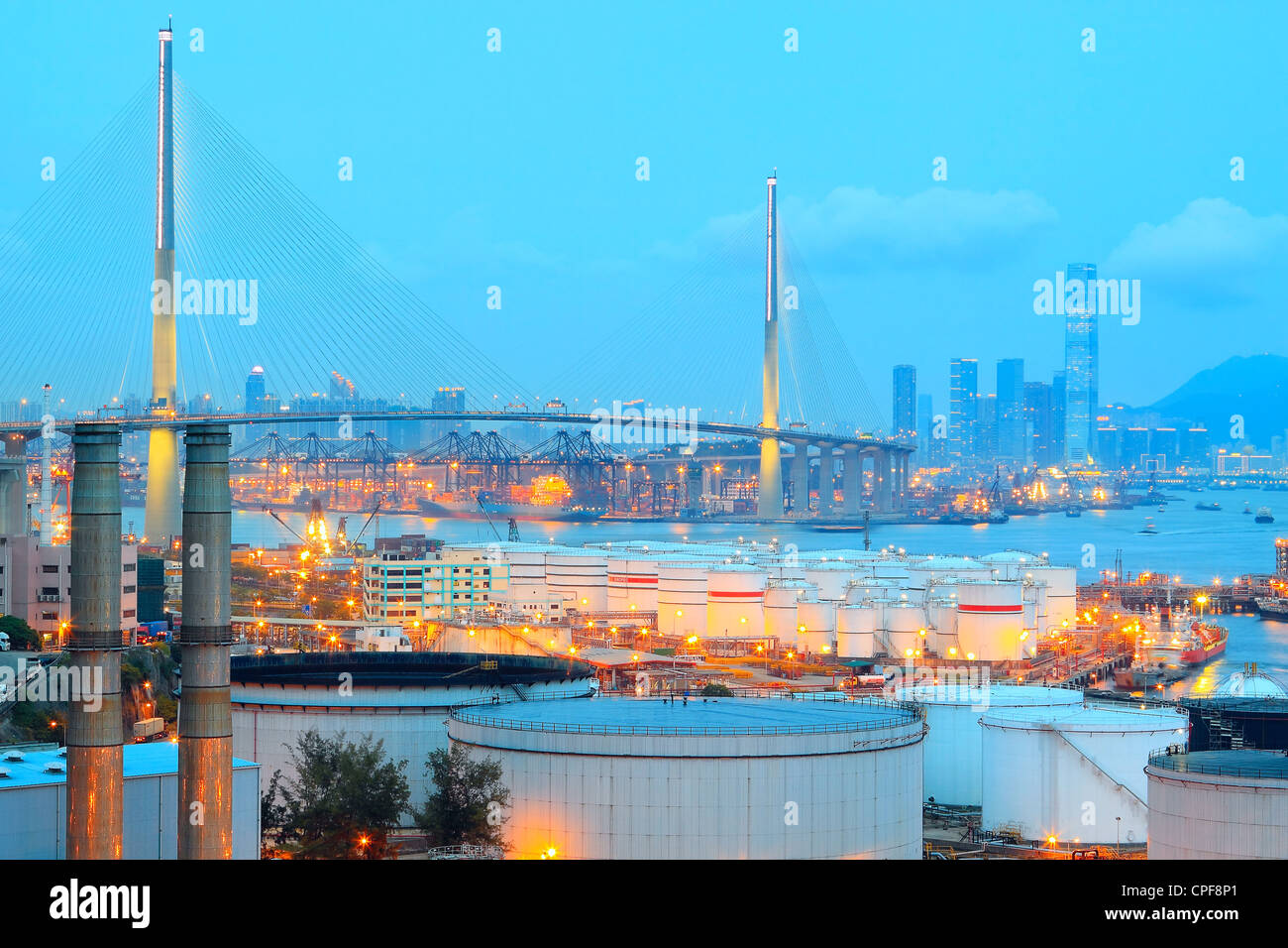 gas tank and highway bridge in sunset moment Stock Photo - Alamy