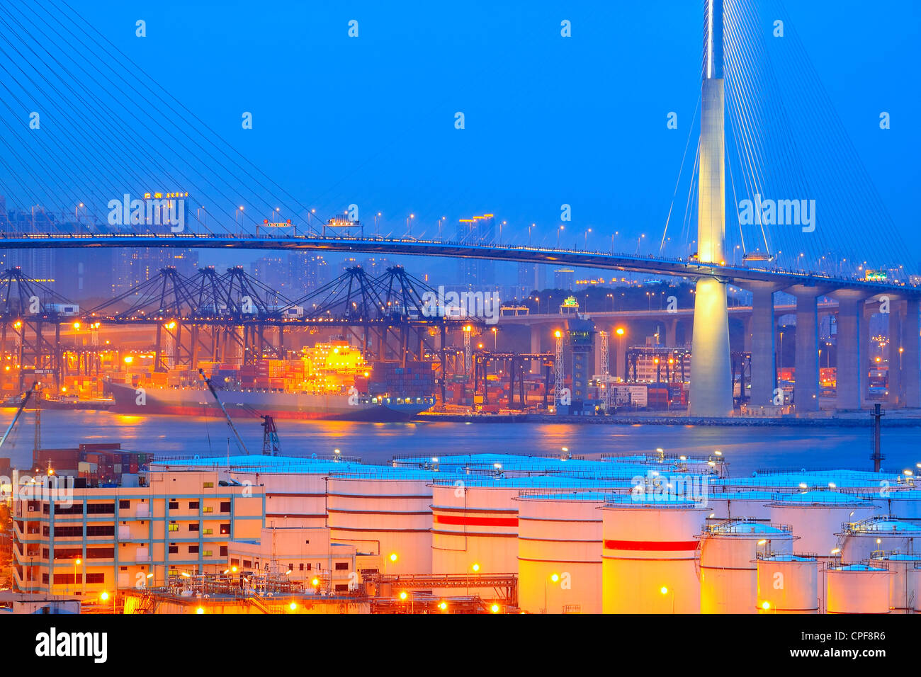gas tank and highway bridge in sunset moment Stock Photo - Alamy