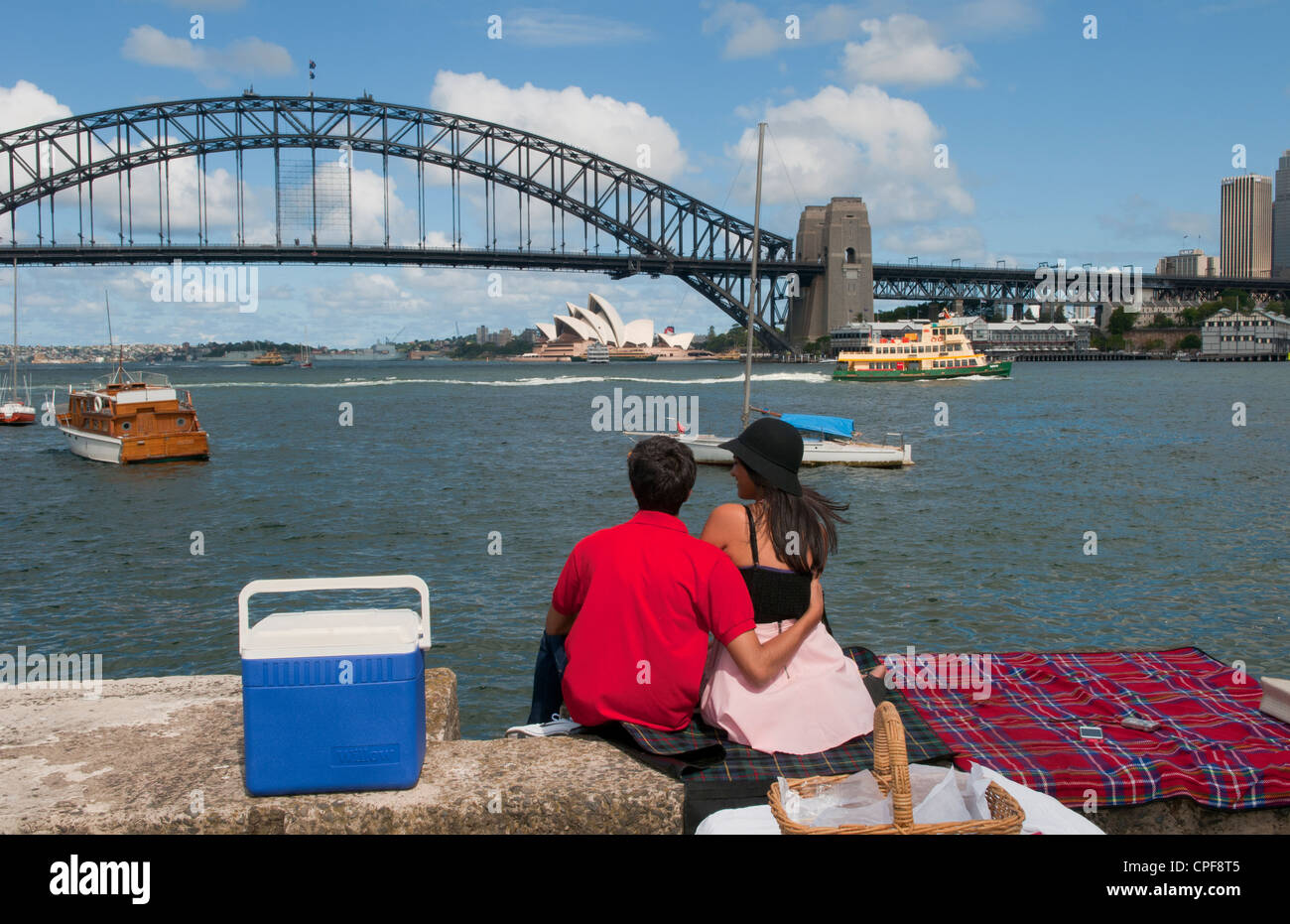 Couple on date at Sydney Harbour with Opera House and Harbour Bridge ...