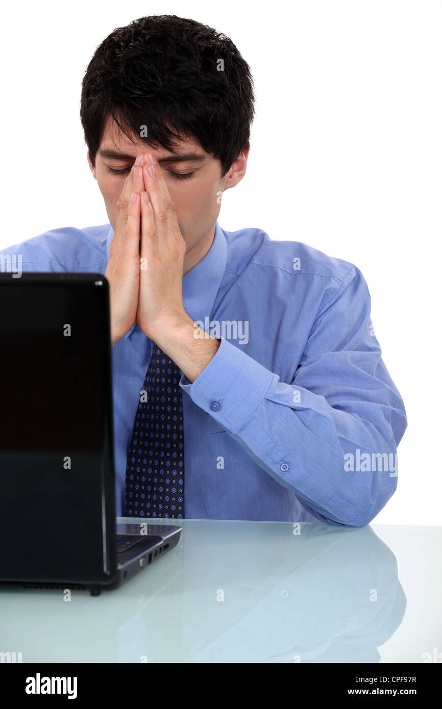 young businessman with laptop looking tired Stock Photo - Alamy