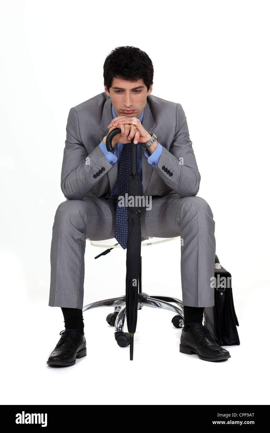A depressed businessman on a chair Stock Photo - Alamy