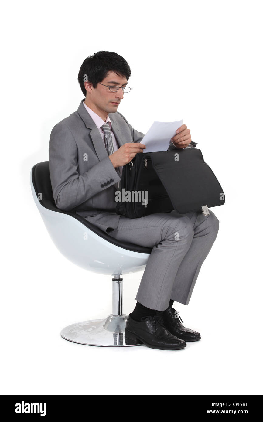 Businessman reading a letter Stock Photo - Alamy