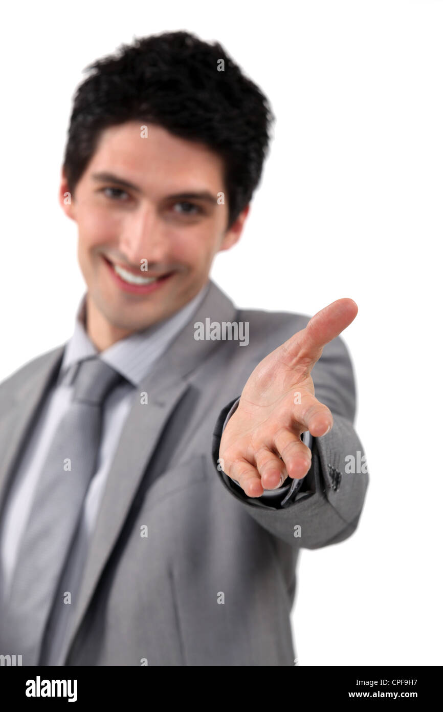 Friendly businessman offering to shake hands Stock Photo - Alamy