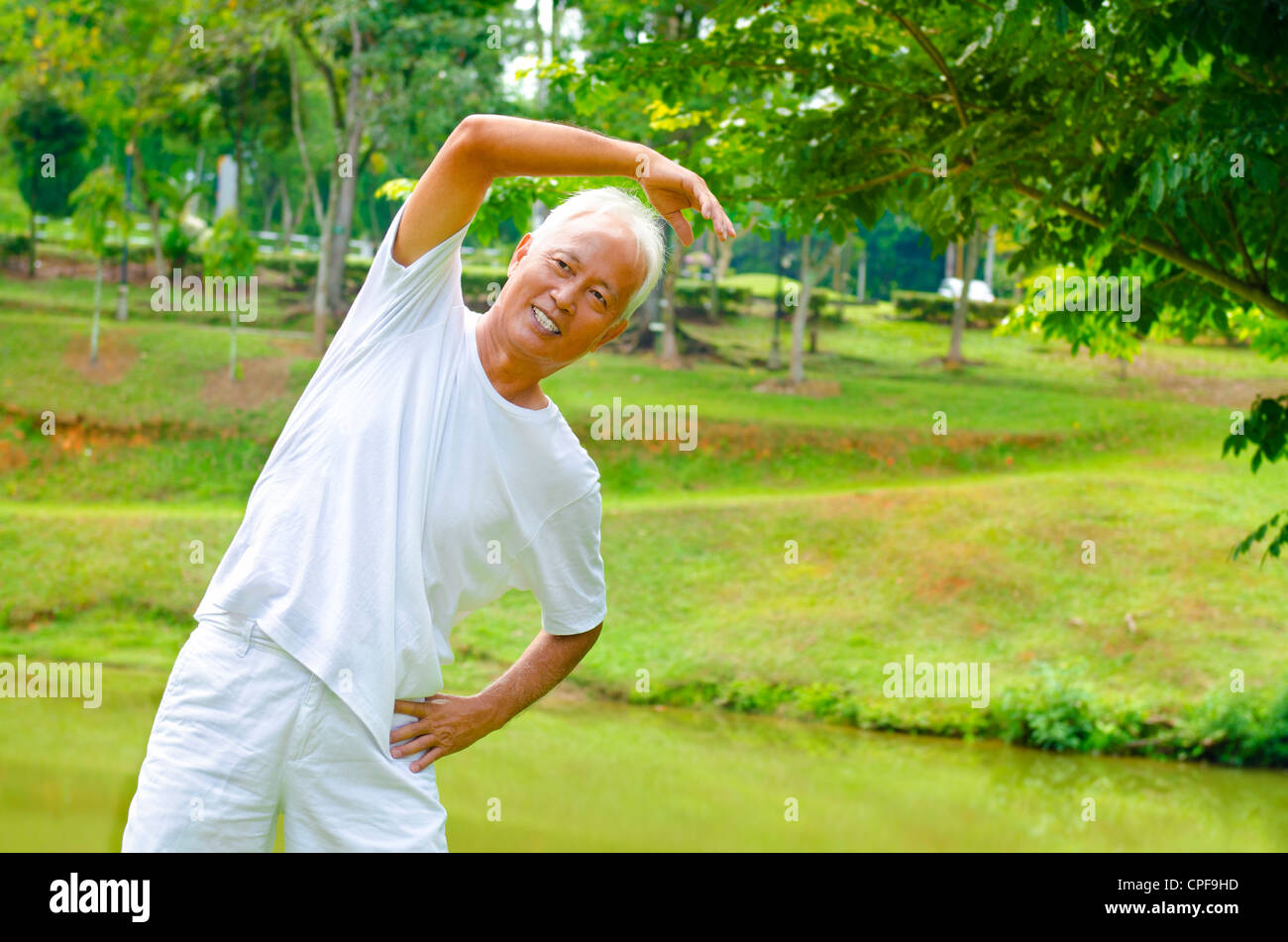 Retired Asian senior man exercising in park Stock Photo - Alamy