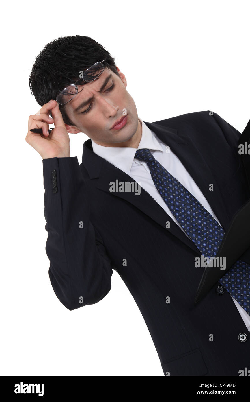 Confused businessman looking at paperwork Stock Photo - Alamy