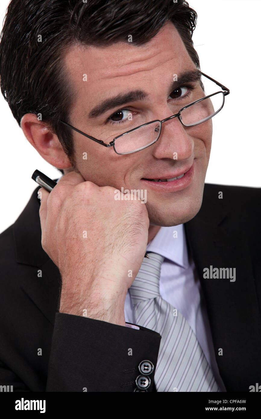 Businessman peering over his glasses Stock Photo - Alamy