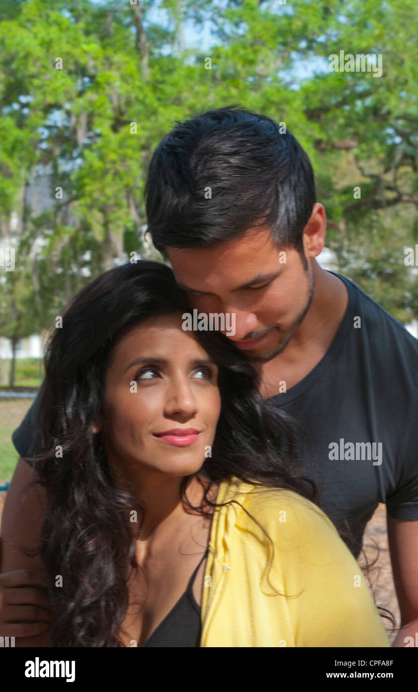 Hispanic Spanish couple in romance situation in park outdoors portrait ...