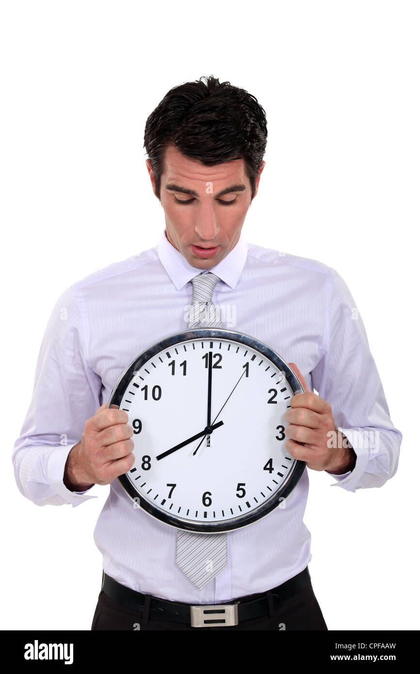 Businessman with a clock Stock Photo - Alamy