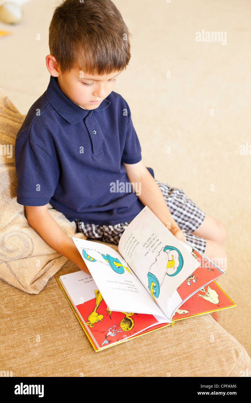 Boy reading a book Stock Photo - Alamy