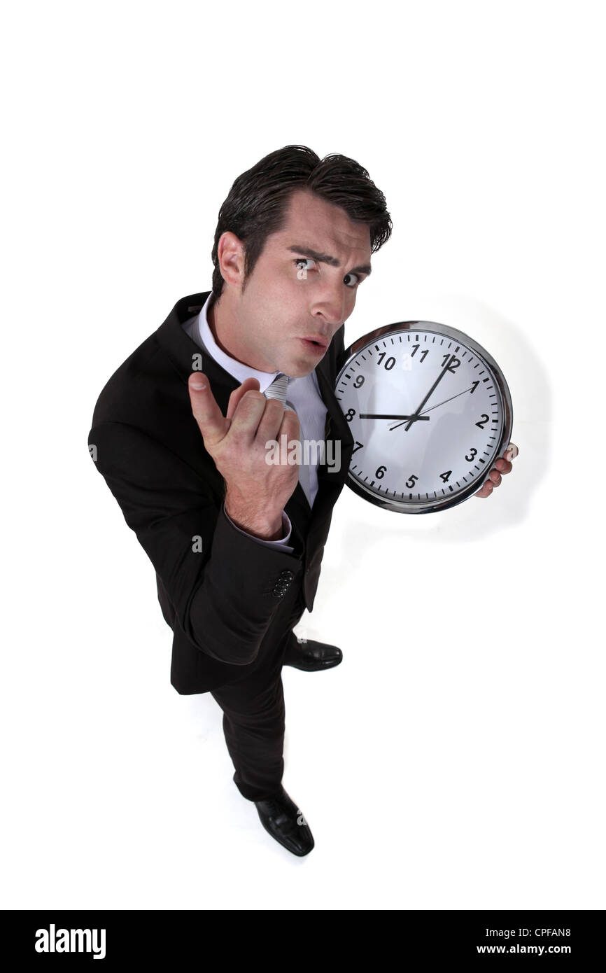Angry boss holding clock Stock Photo - Alamy
