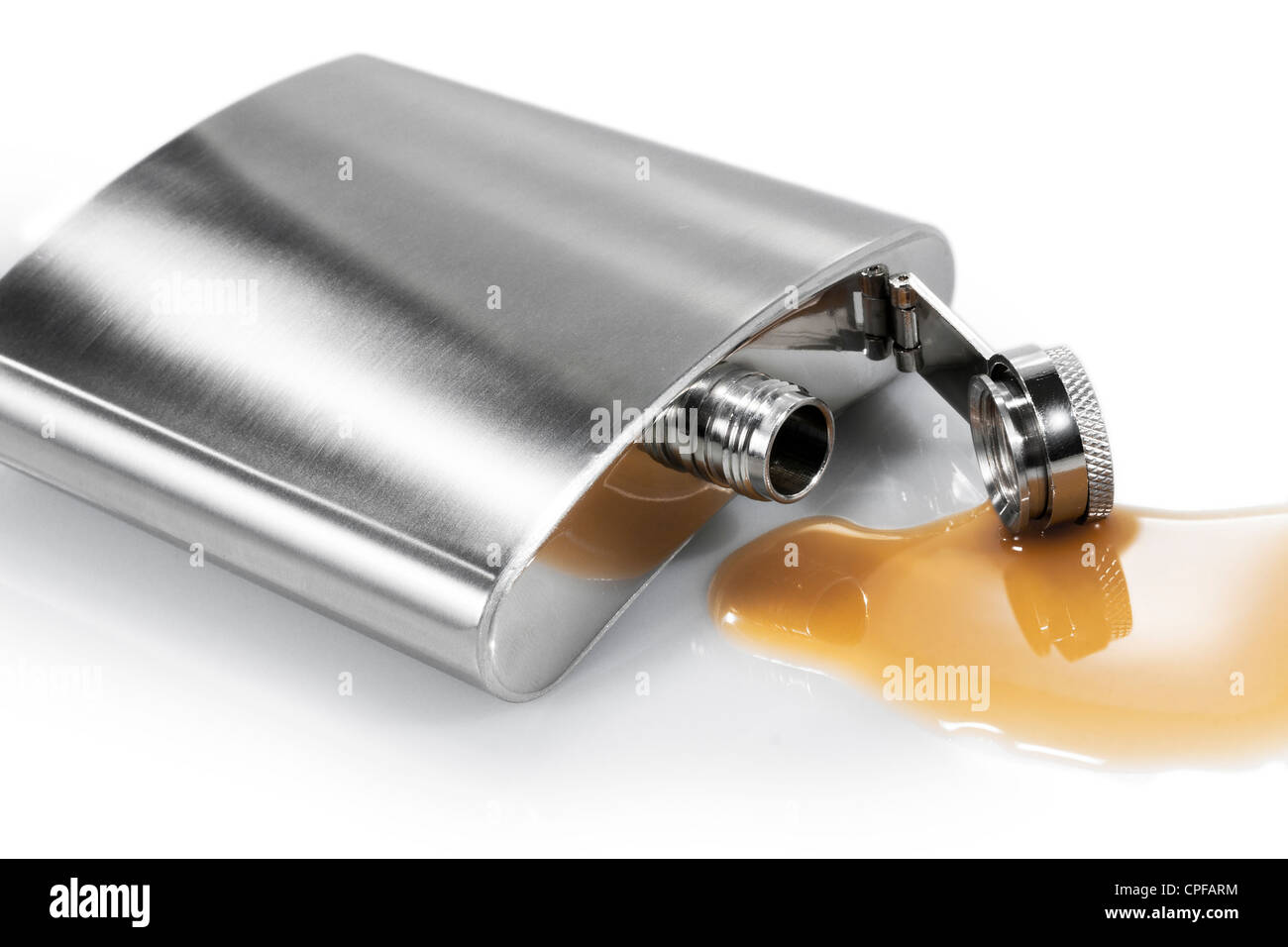 Flask and spilled alcohol on the white background. Isolated Stock Photo ...