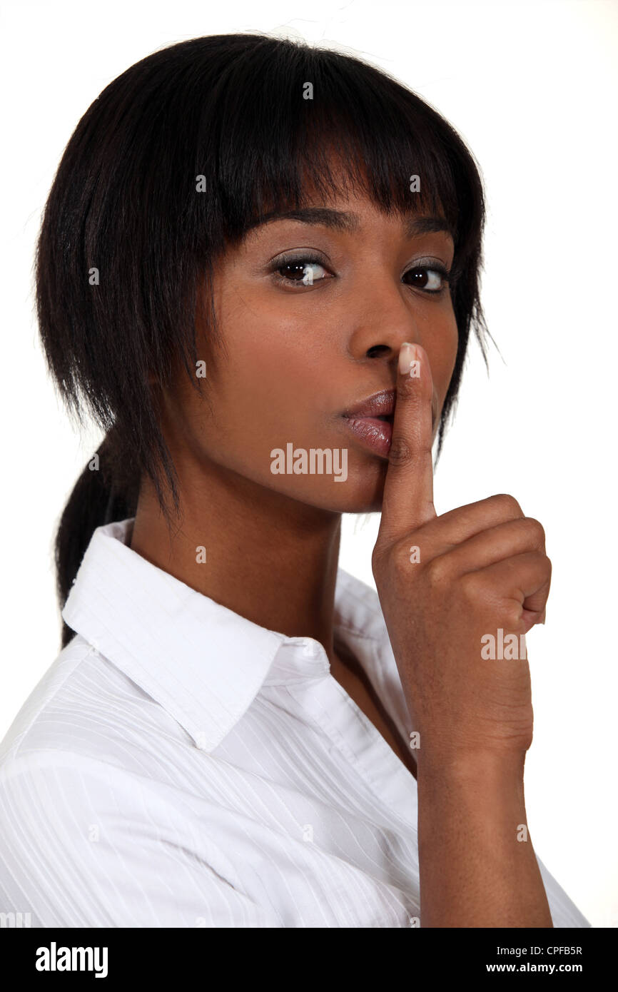 Woman making shush gesture Stock Photo - Alamy
