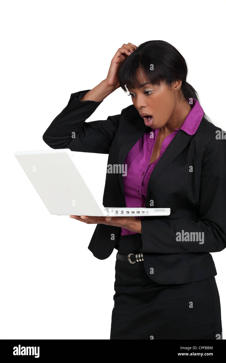 Businesswoman staring in shock at her laptop Stock Photo - Alamy