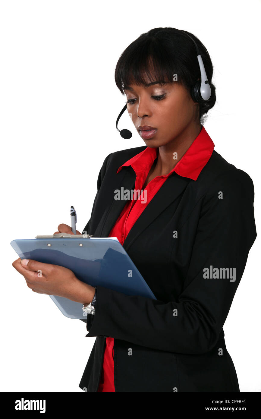 Woman wearing headset writing hi-res stock photography and images - Alamy
