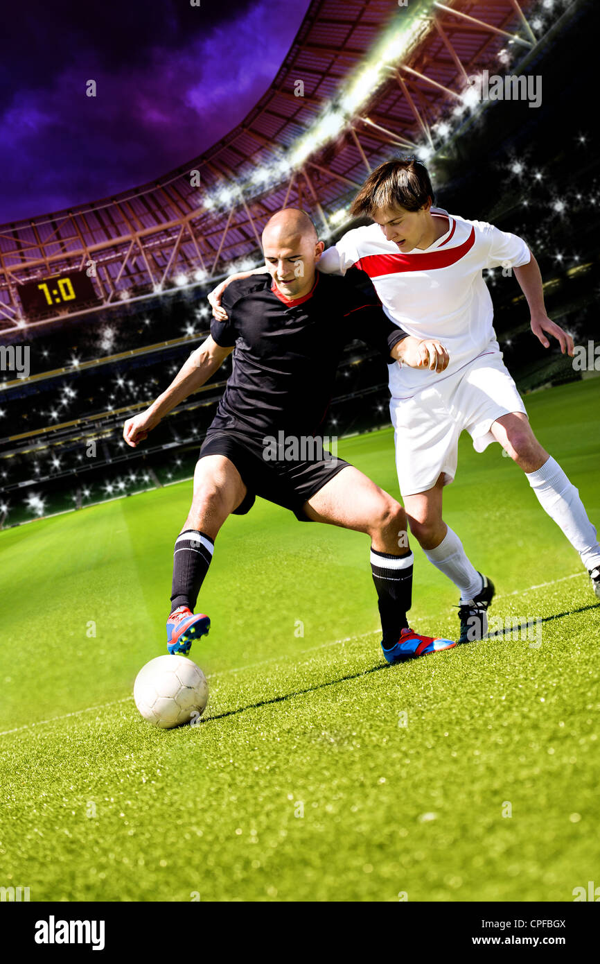 two football players from opposing team on the field Stock Photo - Alamy