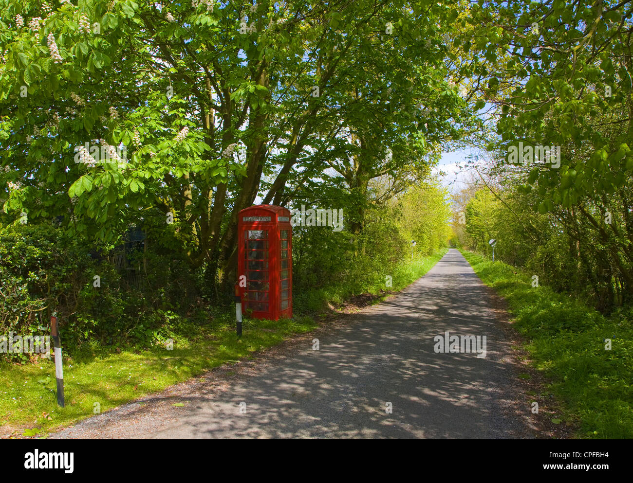 Traditional red telephone box booth in countryside Stock Photo - Alamy