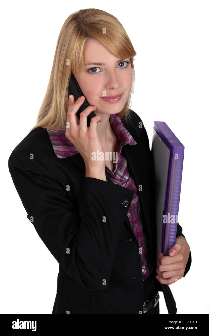 Office worker carrying a file folder while talking on the phone Stock ...