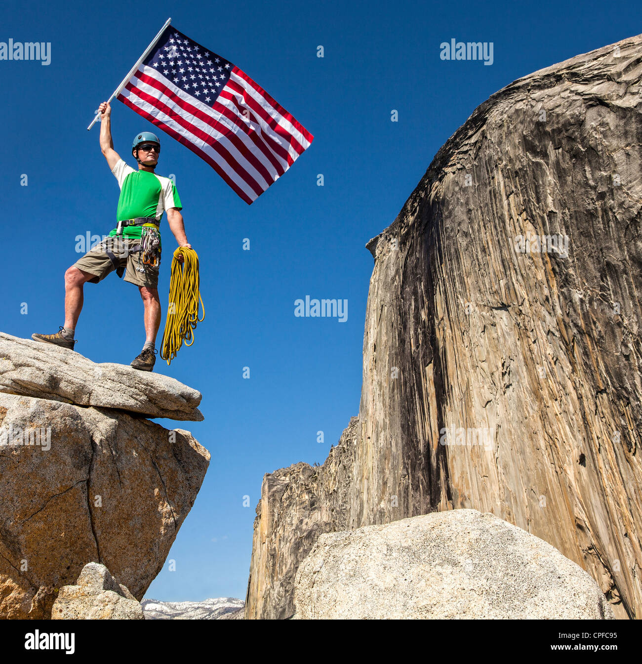 Climber waves an American flag on the summit Stock Photo - Alamy