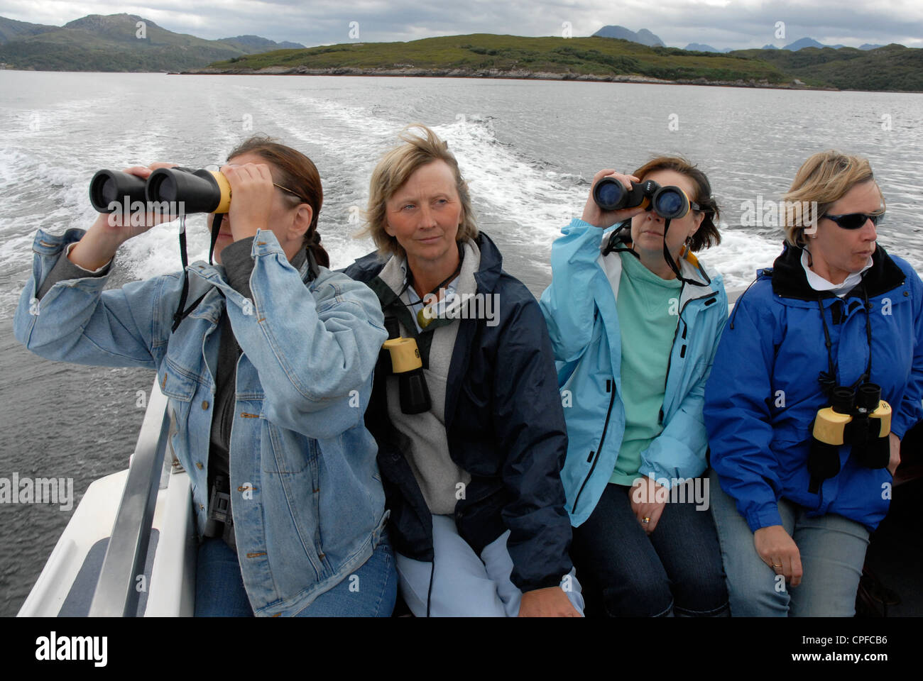 Group of women on a boat trip looking through binoculars Stock Photo ...