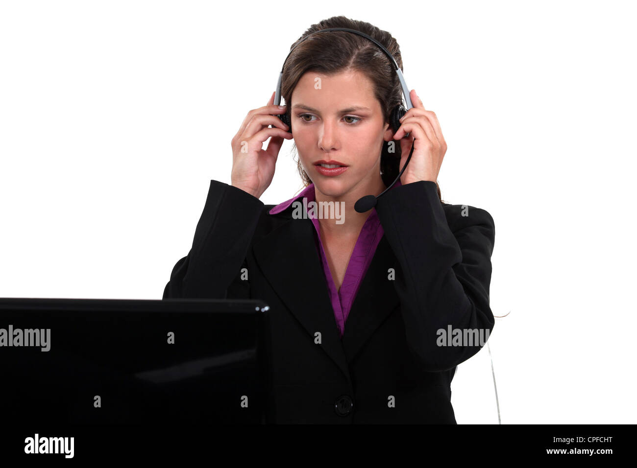 Receptionist putting her headset on Stock Photo - Alamy