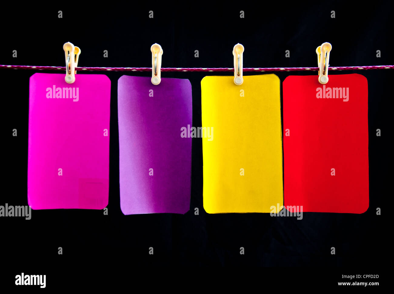 multicolor hang paper on black background Stock Photo - Alamy