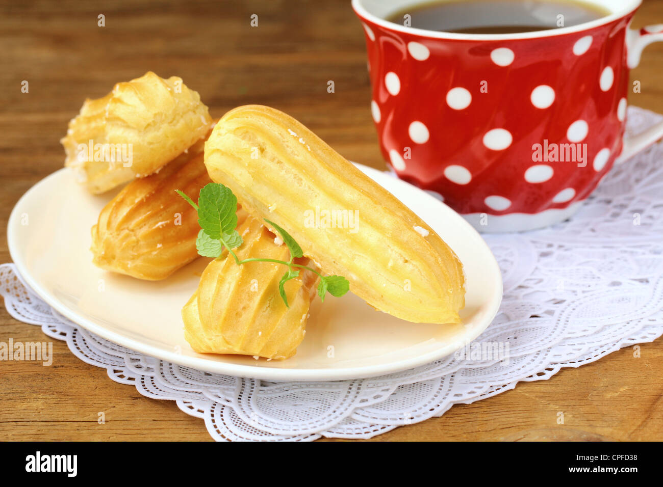 cake eclair profiteroles on a plate Stock Photo - Alamy