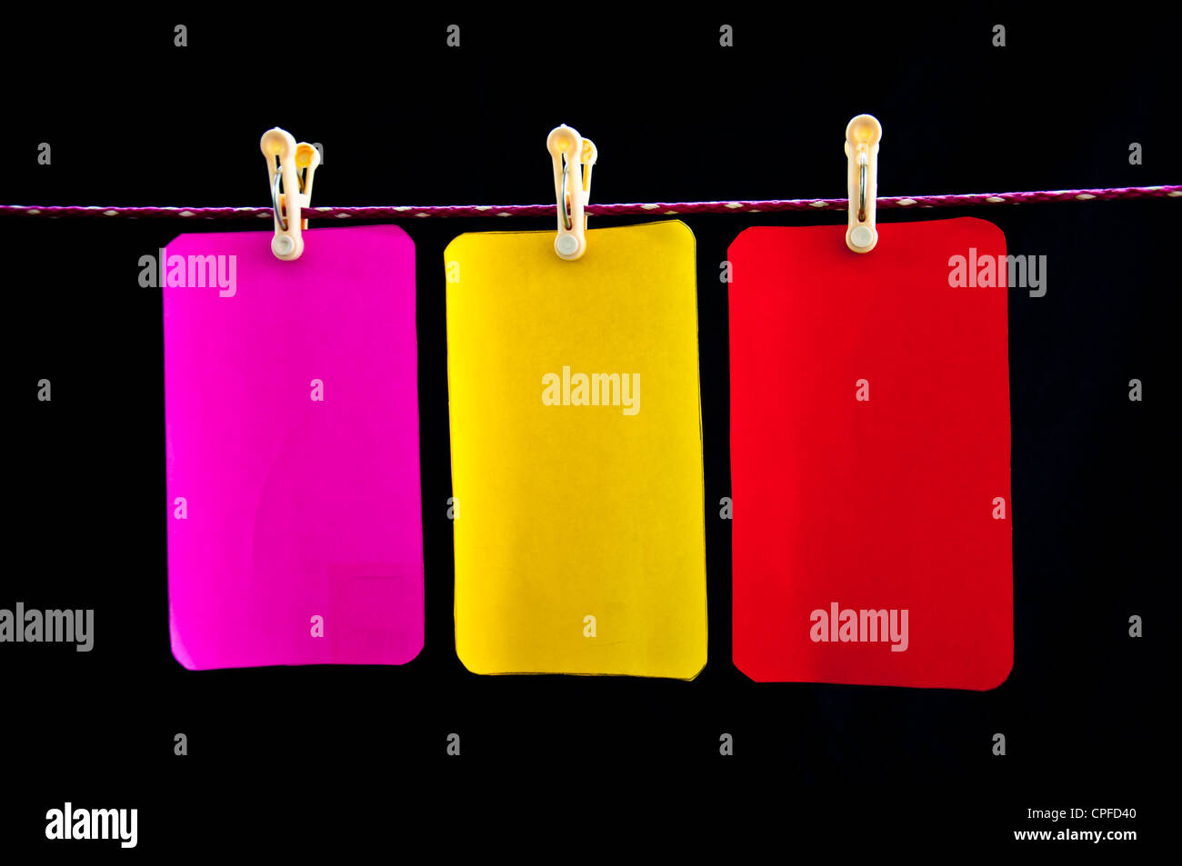 multicolor hang paper on black background Stock Photo - Alamy
