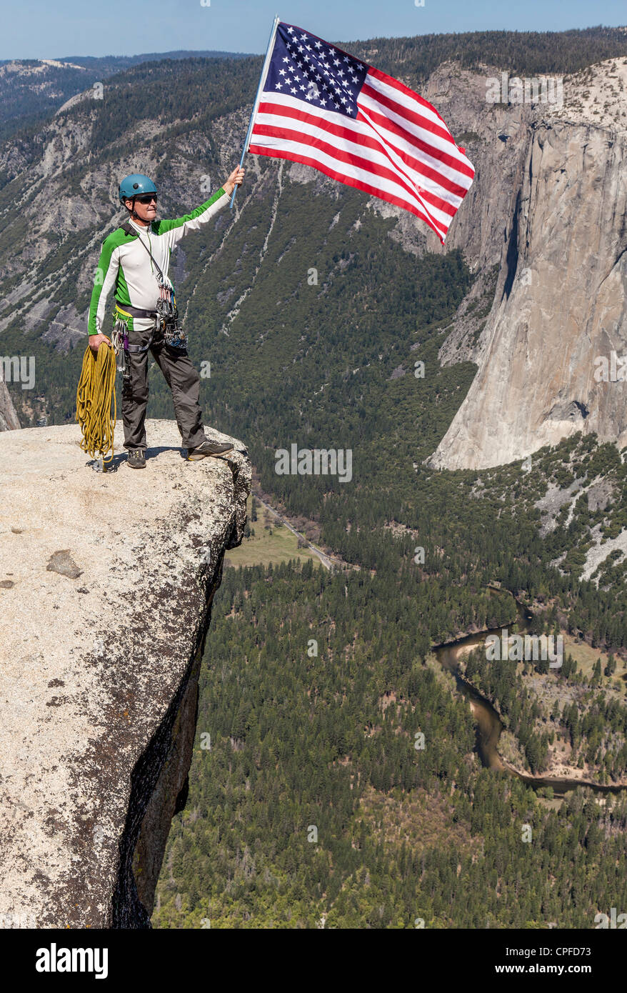 Climber waves an American flag on the summit Stock Photo - Alamy