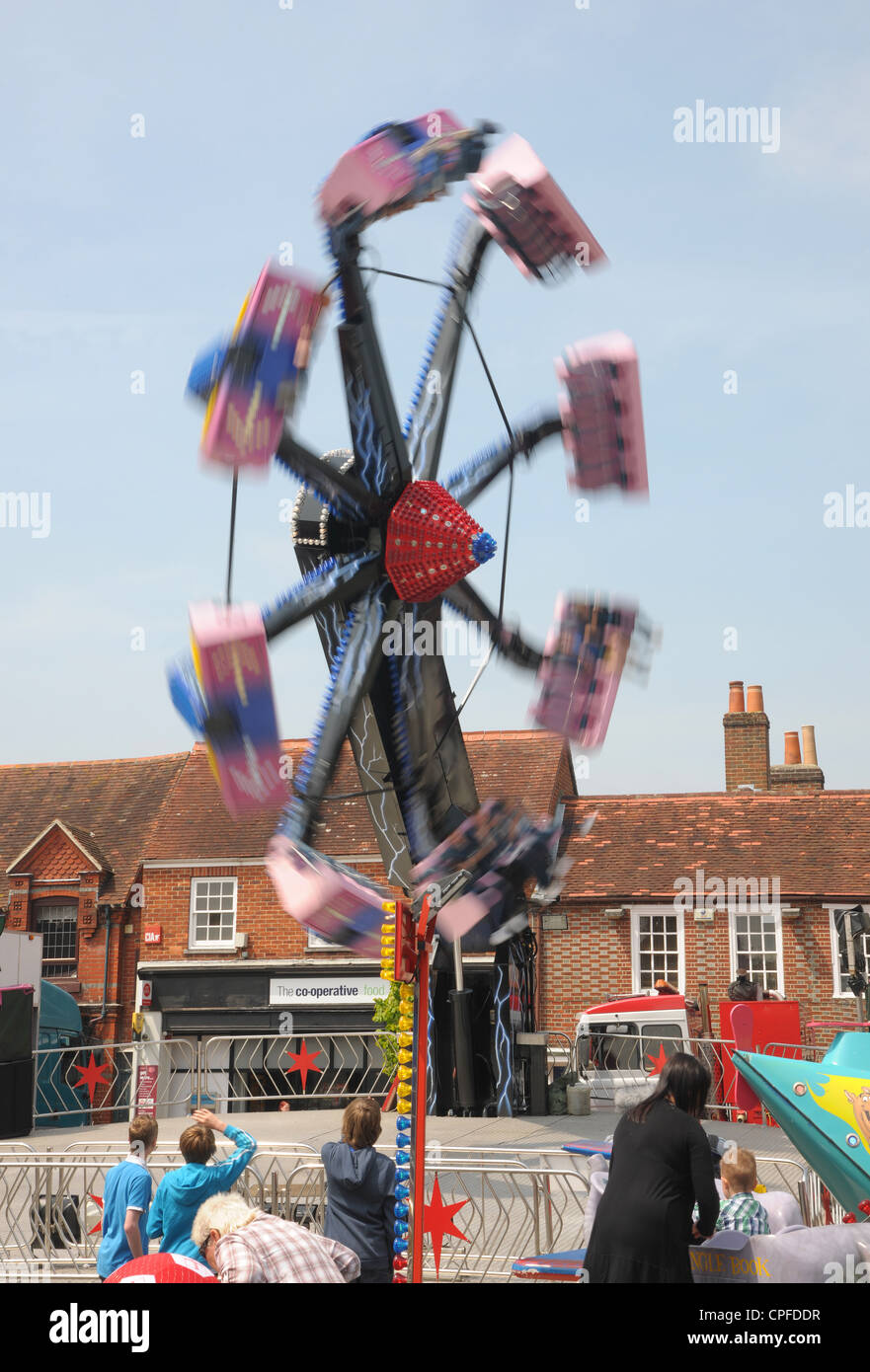 Hampshire. England. May 2012. A fairground ride spinning at high speed ...