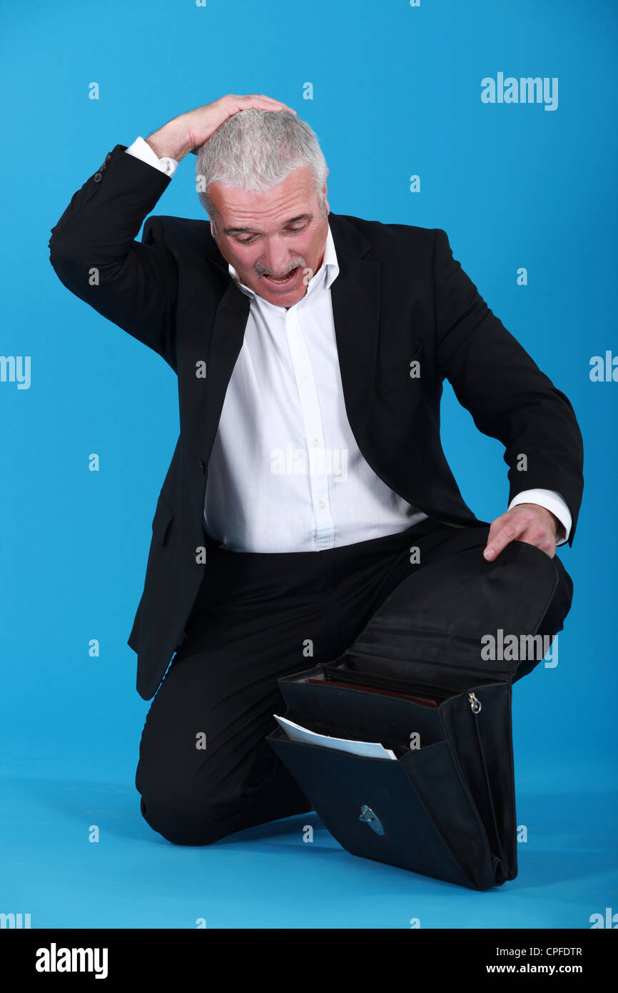 Panicked businessman who forgot a folder Stock Photo - Alamy