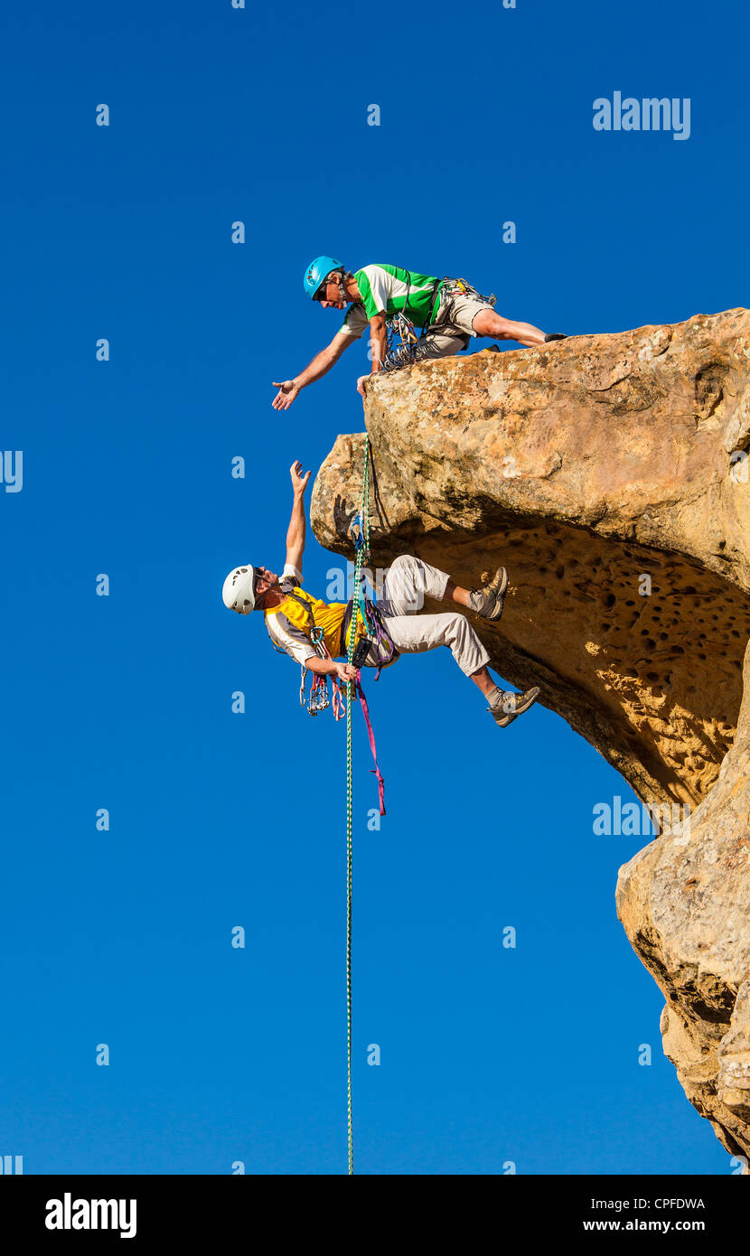 Climbing team struggle to the summit of a challenging rock mountain ...
