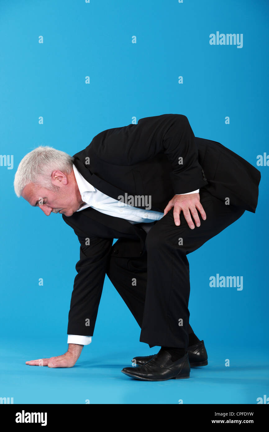 Man touching the floor Stock Photo - Alamy