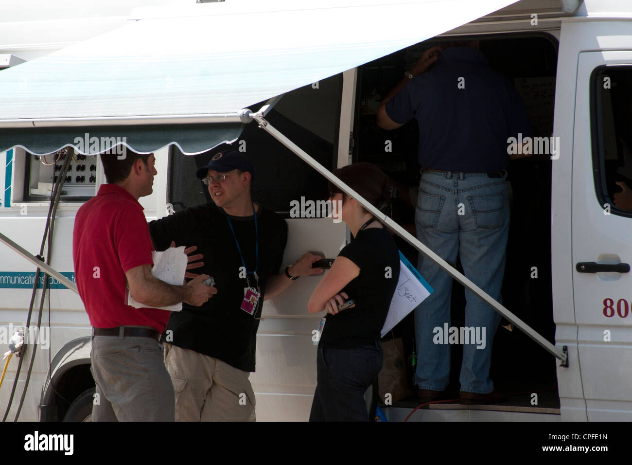 news reporters discussing talking by news van Stock Photo - Alamy