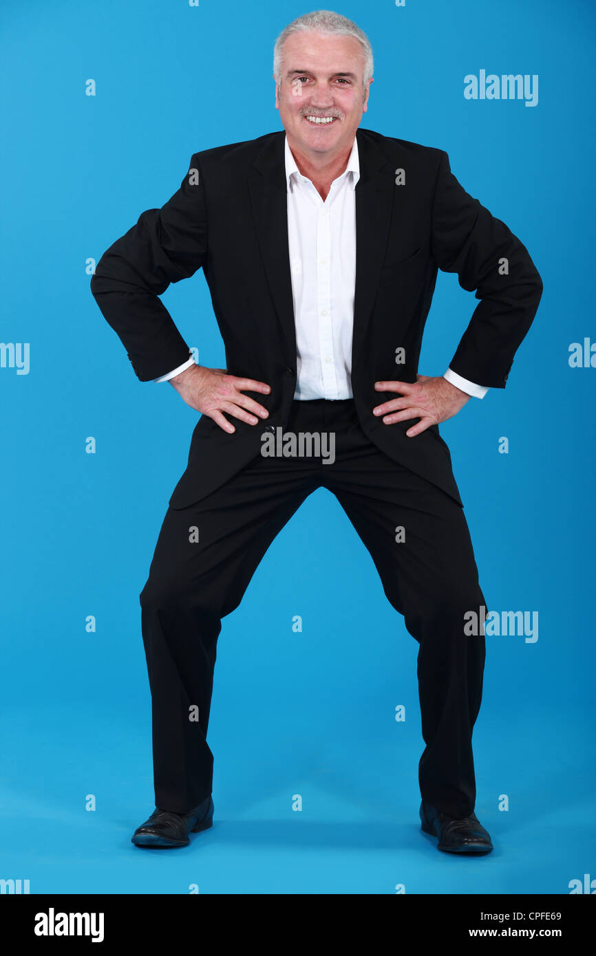 Elderly man bending the legs Stock Photo - Alamy