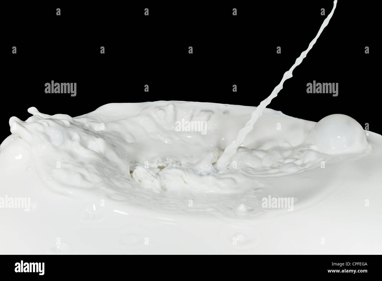 splashing milk isolated on black background Stock Photo - Alamy