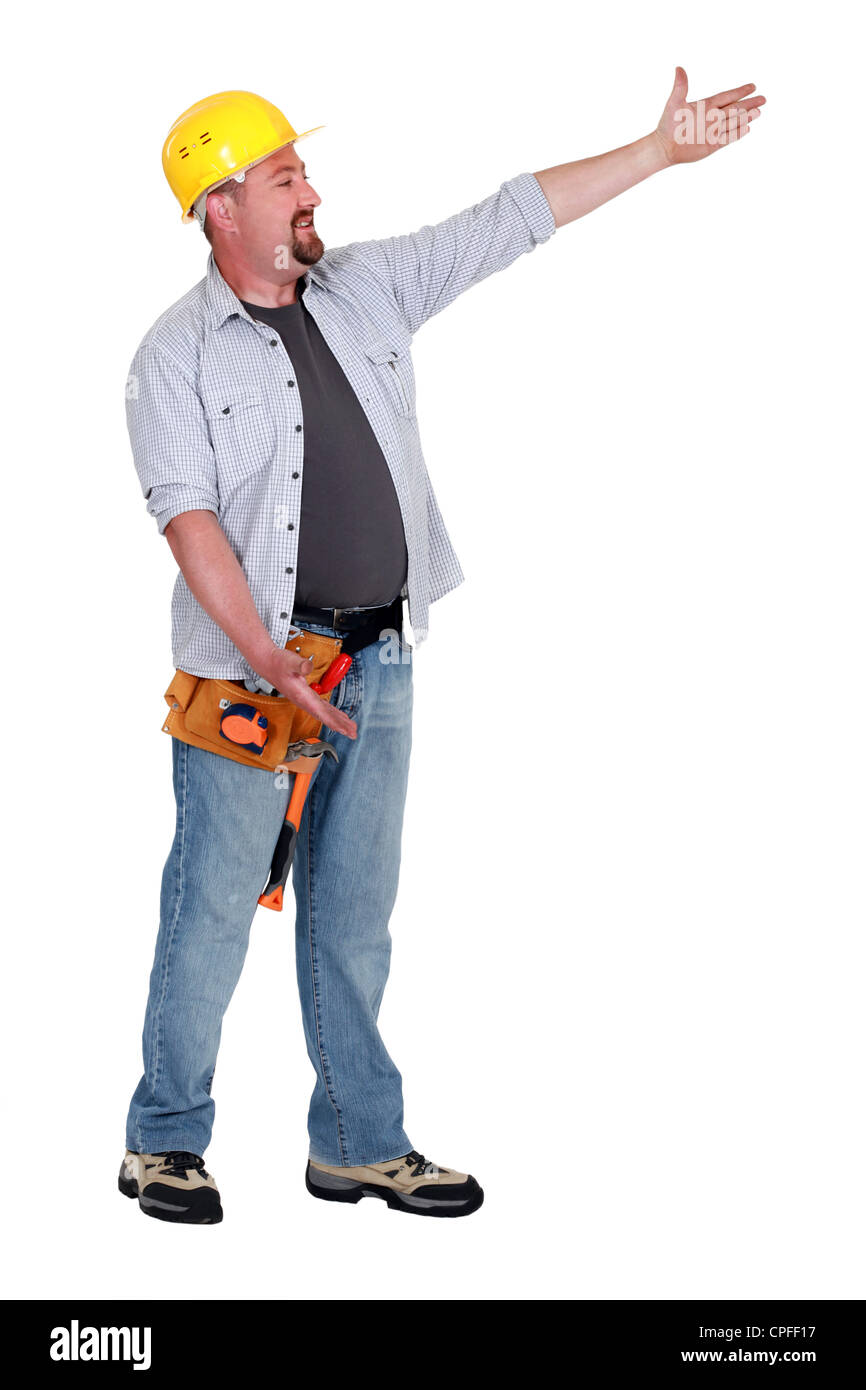 Tradesman presenting an invisible object Stock Photo - Alamy