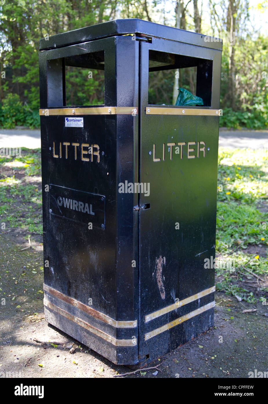 A black litter bin with gold effect trim Stock Photo - Alamy