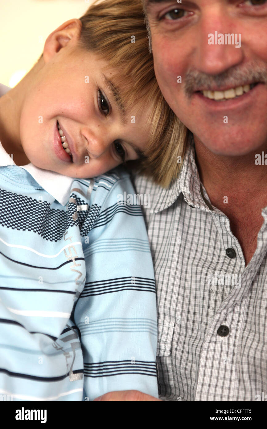 Man hugging a young boy Stock Photo - Alamy