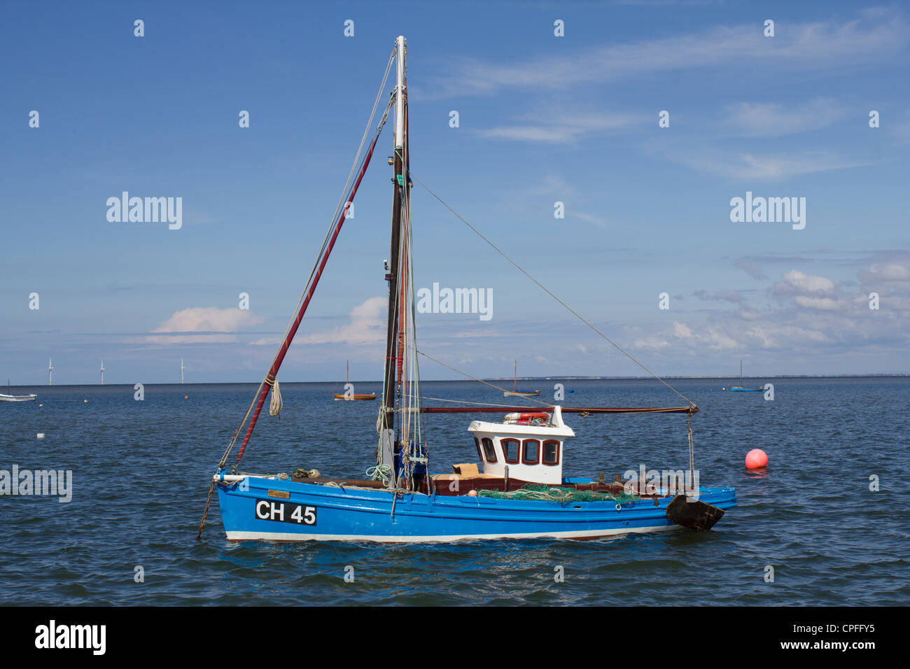 A blue and white boat, moored in the estuary of the River Mersey Stock ...