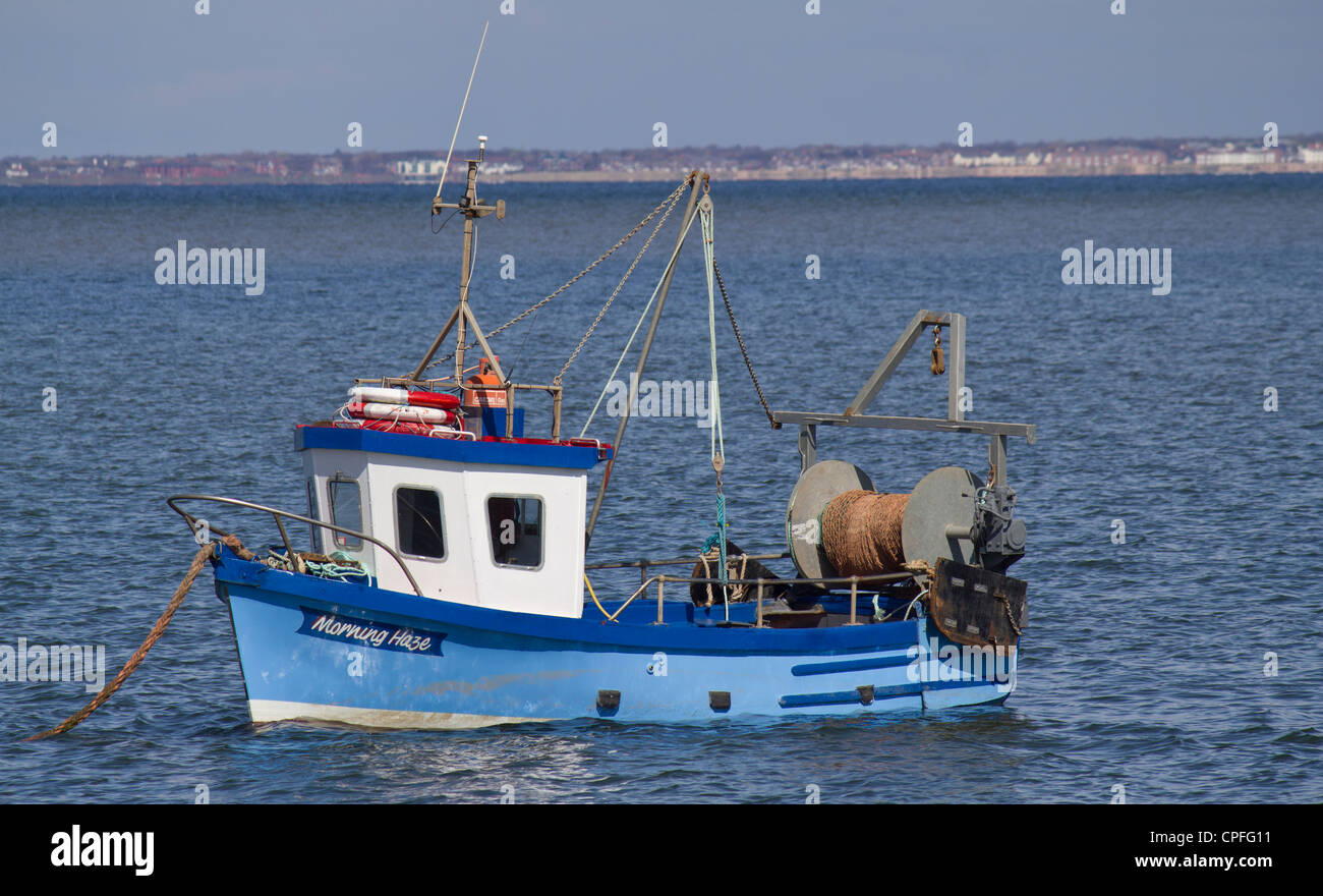 A blue and white boat, moored in the estuary of the River Mersey Stock ...