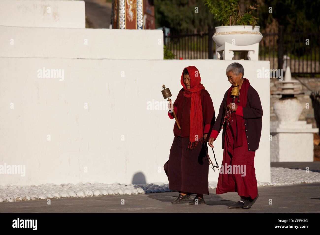 Nuns walk clockwise around the National Memorial Chorten. Thimphu ...