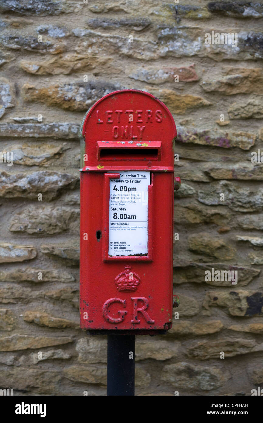 An old red letter box by a stone wall Stock Photo - Alamy